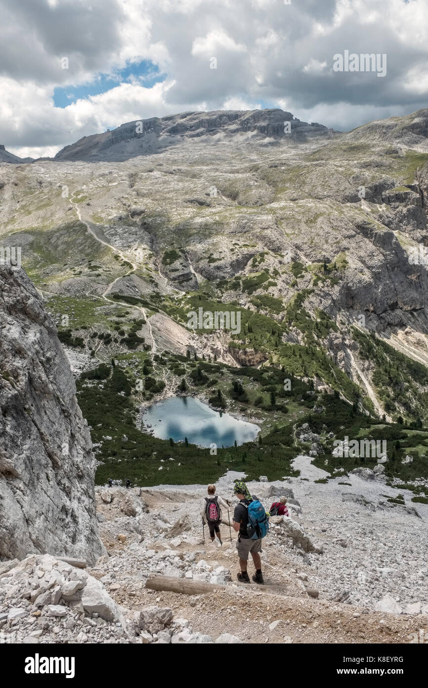 The Dolomites, Northern Italy. Hikers descending the dramatic Forcella ...