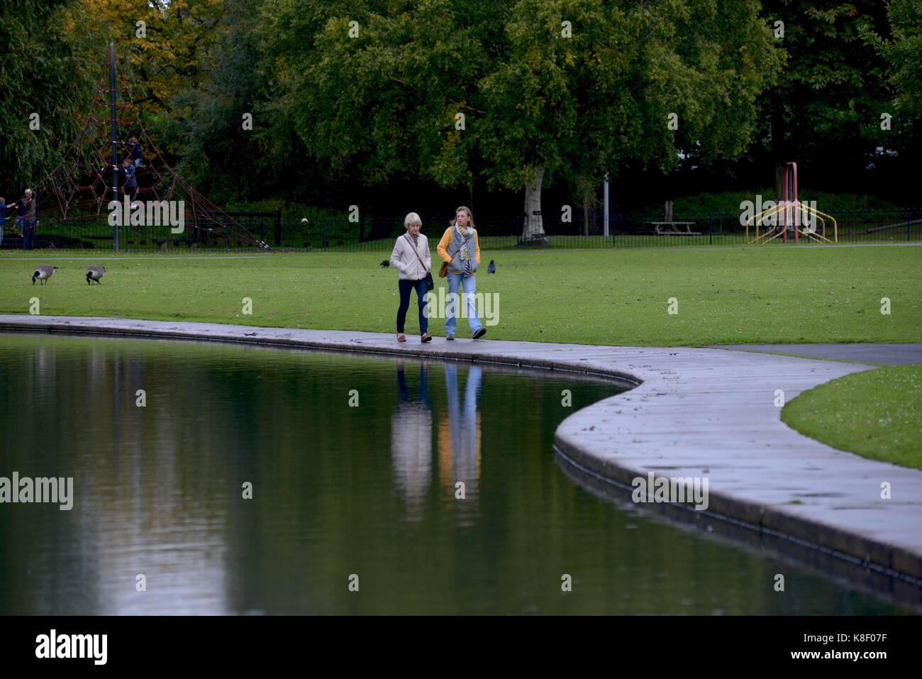 Two people enjoying a walk in Rowntree Park, York, North Yorkshire, UK ...