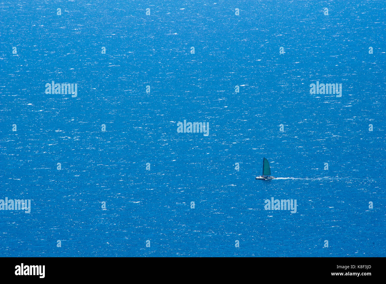 Small yacht sailing in open ocean Stock Photo - Alamy