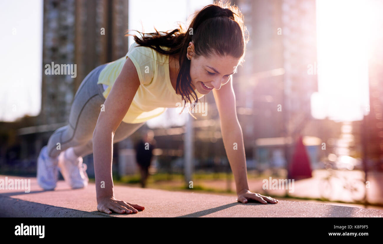 Picture of woman doing push ups in urban area Stock Photo - Alamy