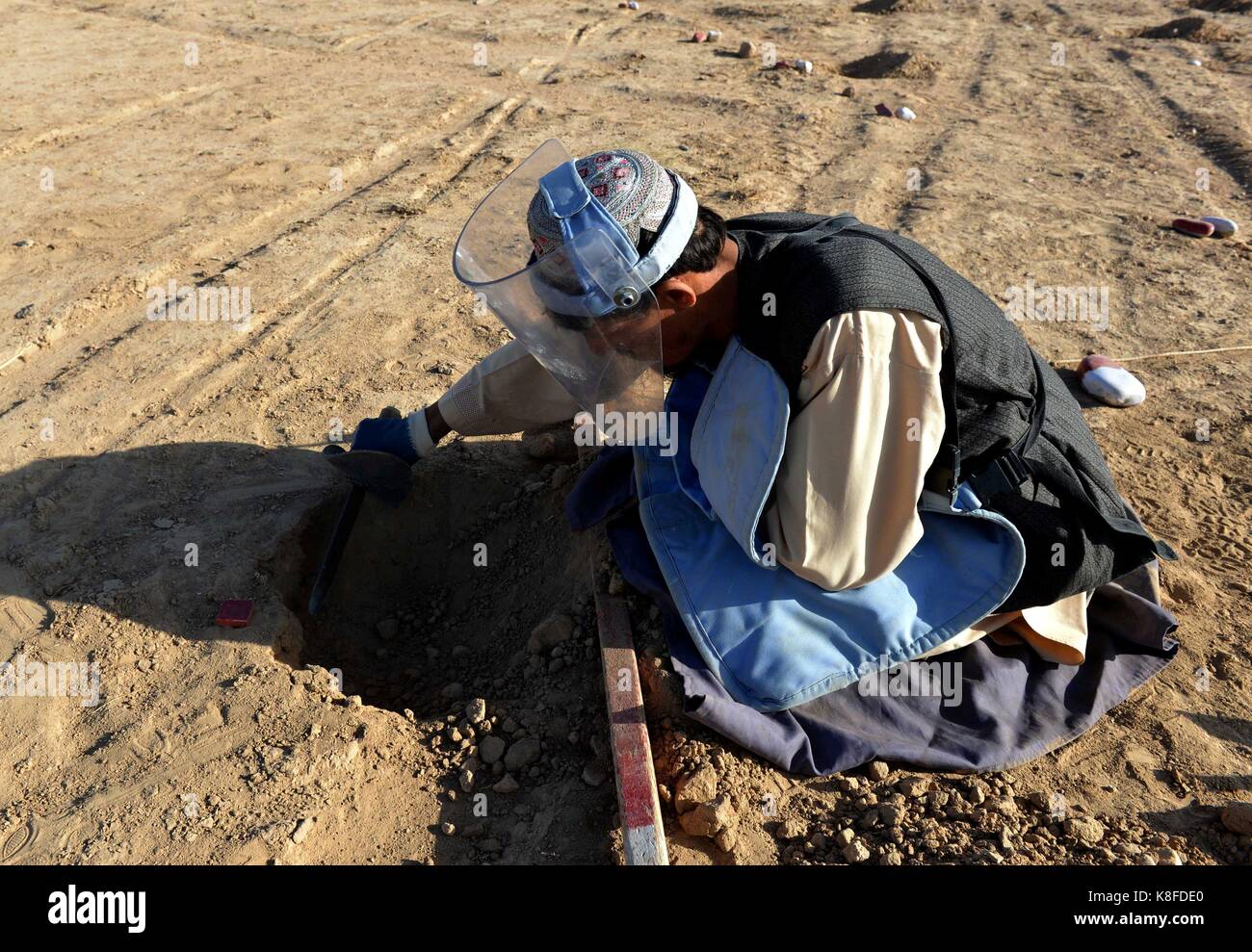 Kandahar, Afghanistan. 18th Sep, 2017. An Afghan de-miner searches for ...