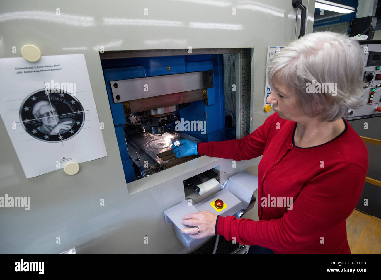 Minter Carmen Lahr takes a newly minted 2-Euro-coin with the portrait ...