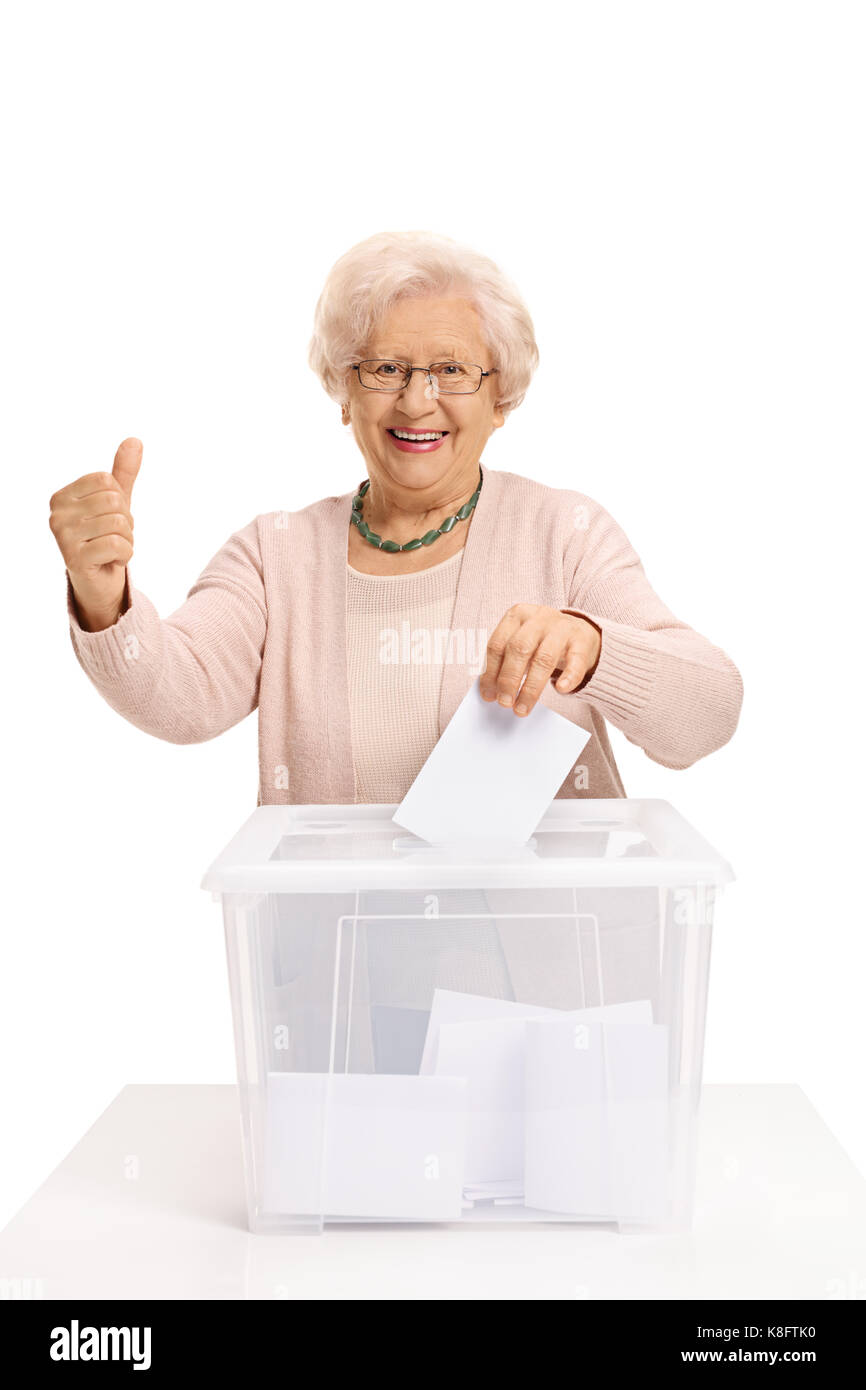 Elderly woman voting and making a thumb up sign isolated on white ...