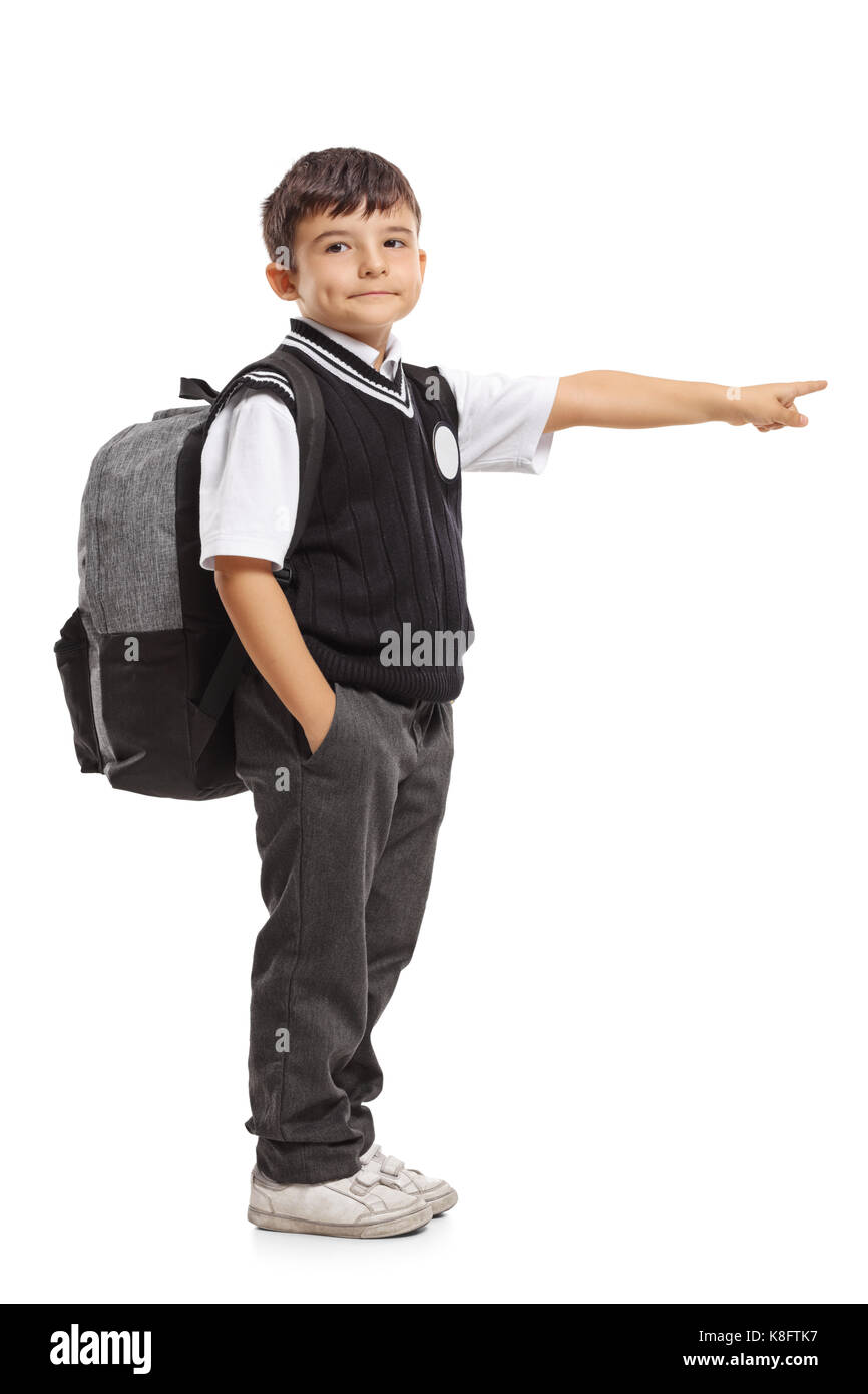 Full length portrait of a schoolboy with a backpack pointing isolated ...