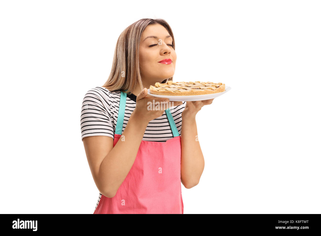 Young woman smelling a freshly baked pie isolated on white background ...