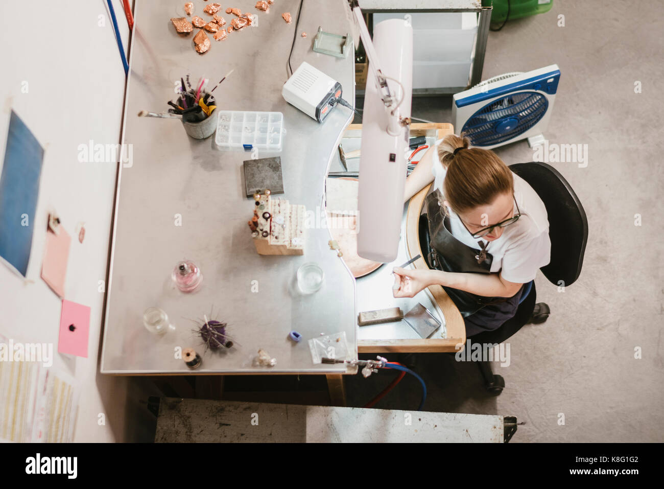 Overhead view of female jeweller at workbench Stock Photo - Alamy