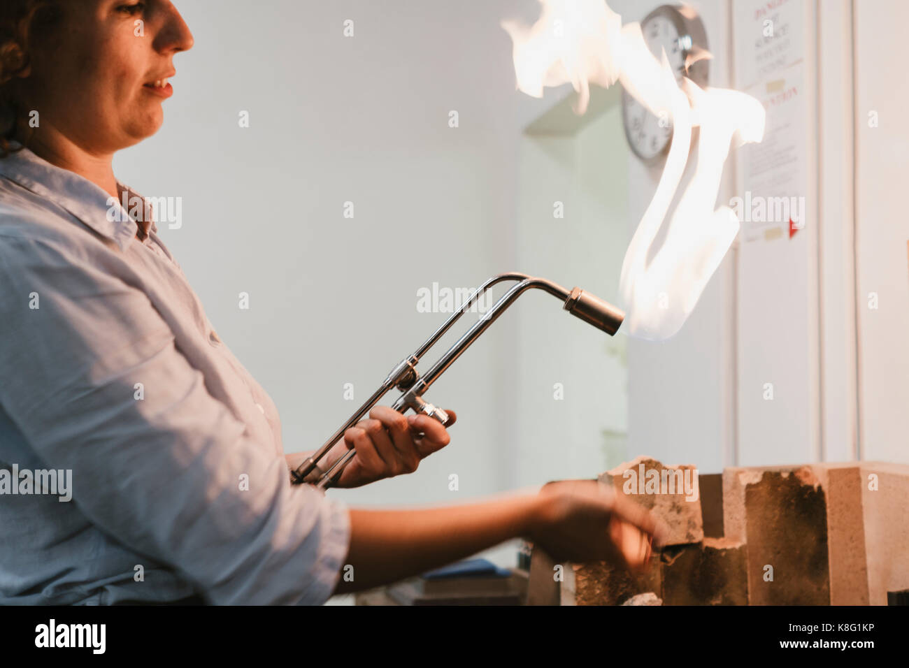 Female jeweller using flaming blow torch at workbench Stock Photo - Alamy