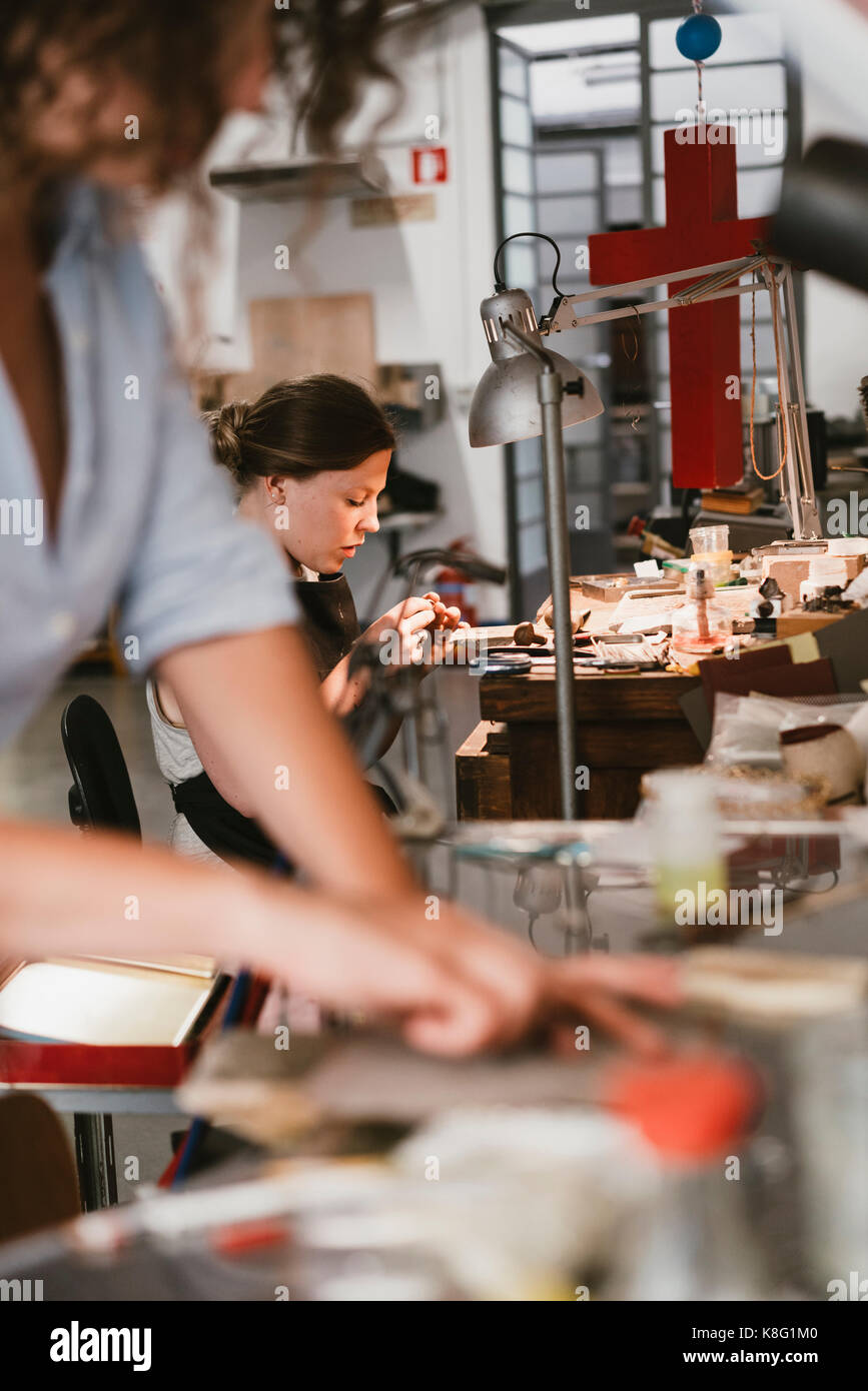 Two female jewellers at work in jewellery workshop Stock Photo - Alamy