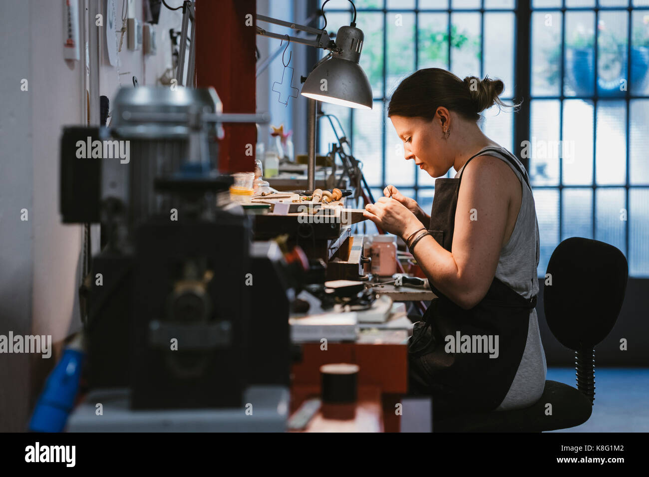 Female jeweller at work in jewellery workshop Stock Photo - Alamy
