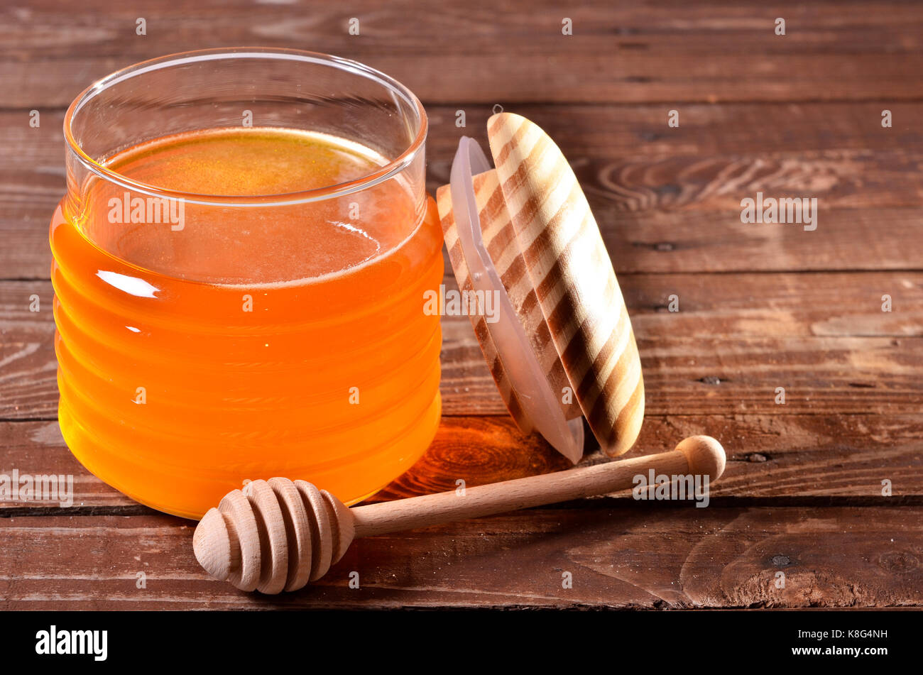 jar with honey and stick for honey Stock Photo - Alamy