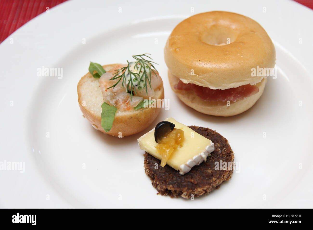 Afternoon tea food items on a white plate Stock Photo - Alamy