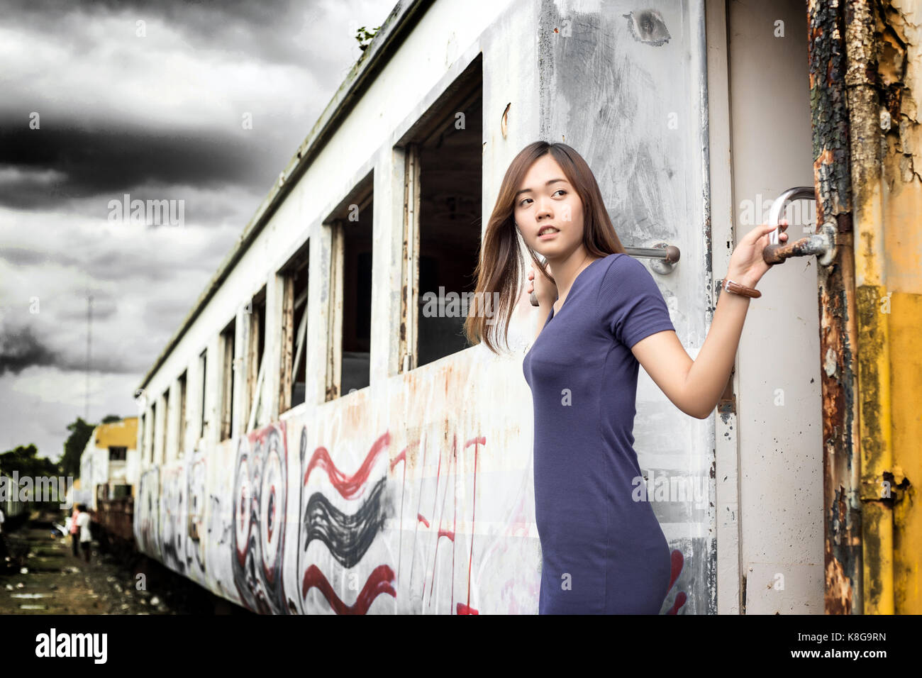 asian thai lady model post action tourism hold old train in dark clound ...
