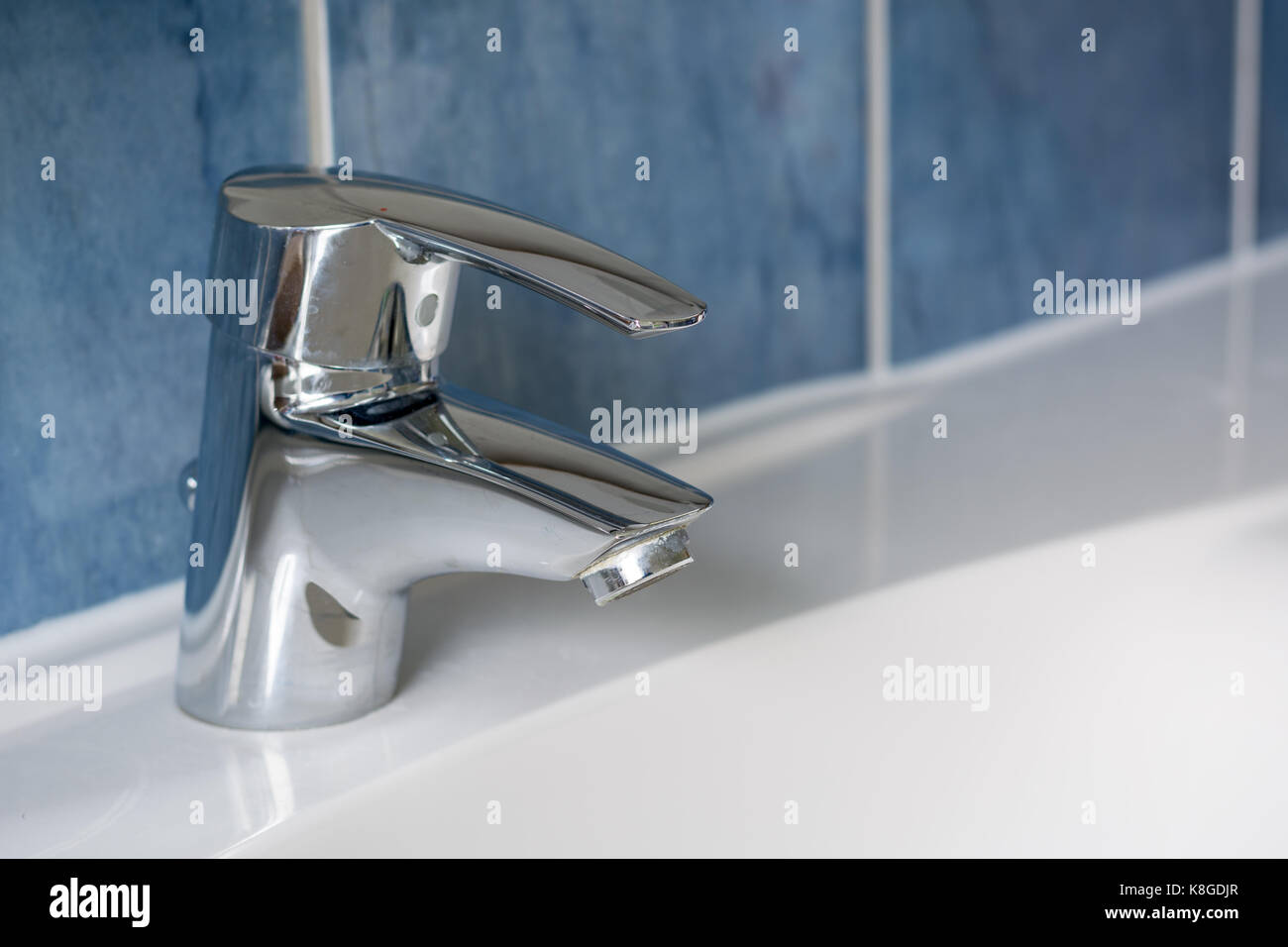 Chrome water tap in the bathroom from the side Stock Photo - Alamy