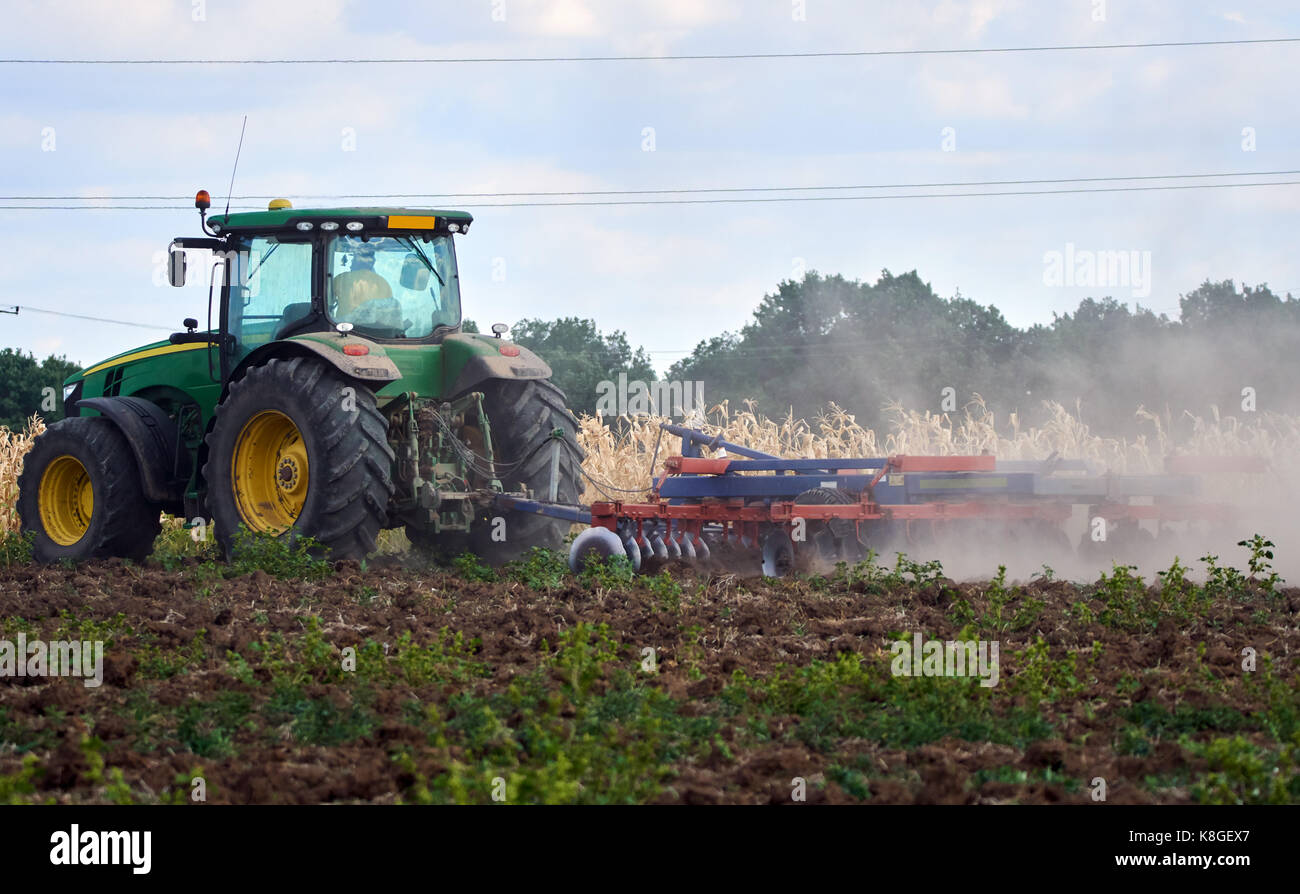 Tractor harrowing plowed fields for autumn agricultural works Stock ...