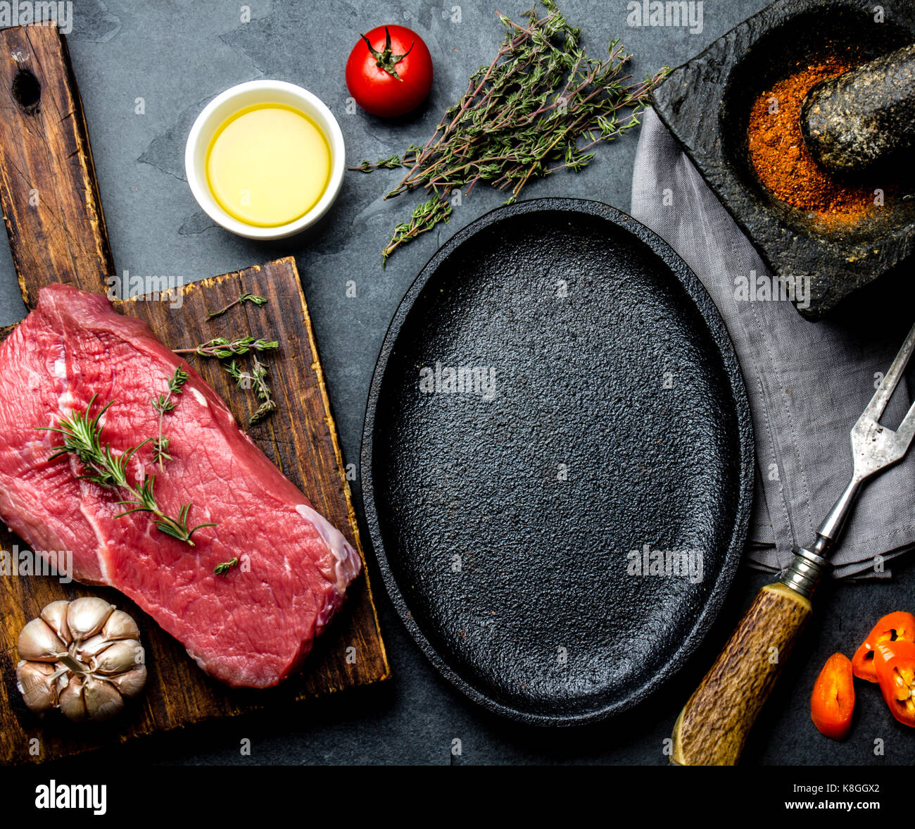 Raw fresh meat steak beef tenderloin, herbs and spices around frying ...