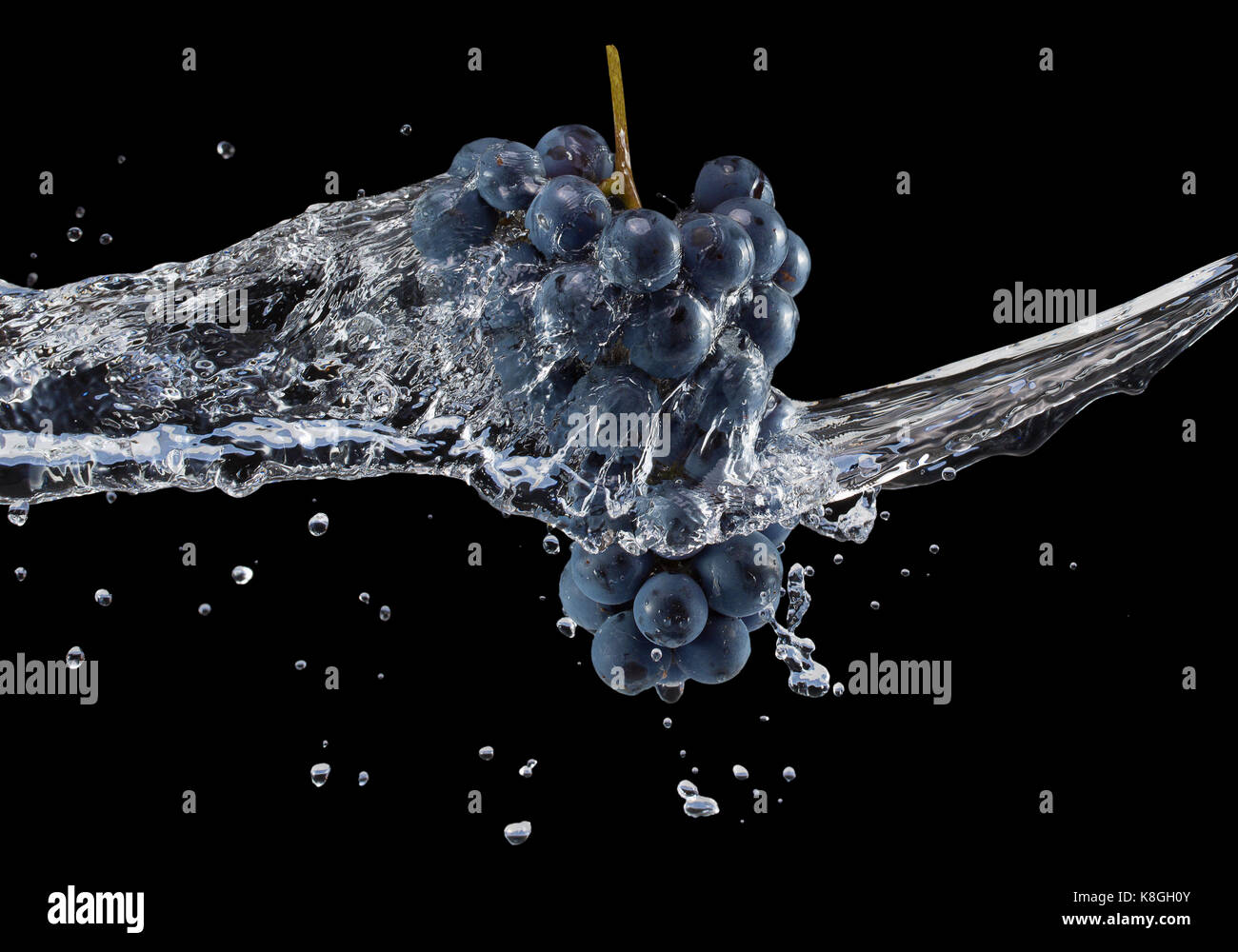 purple grapes in water splash on a black background Stock Photo - Alamy