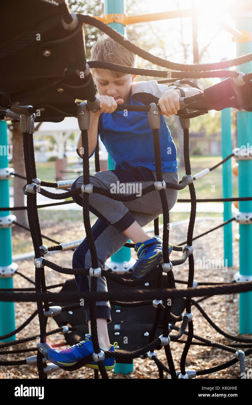 Boy playing in playground Stock Photo - Alamy