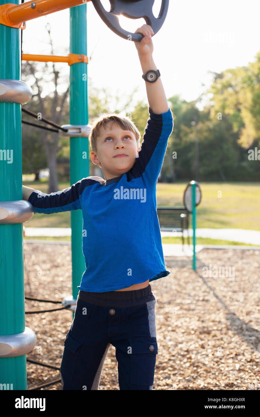 Boy playing in playground Stock Photo - Alamy