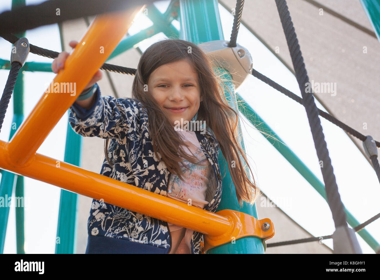 Girl playing in playground Stock Photo - Alamy