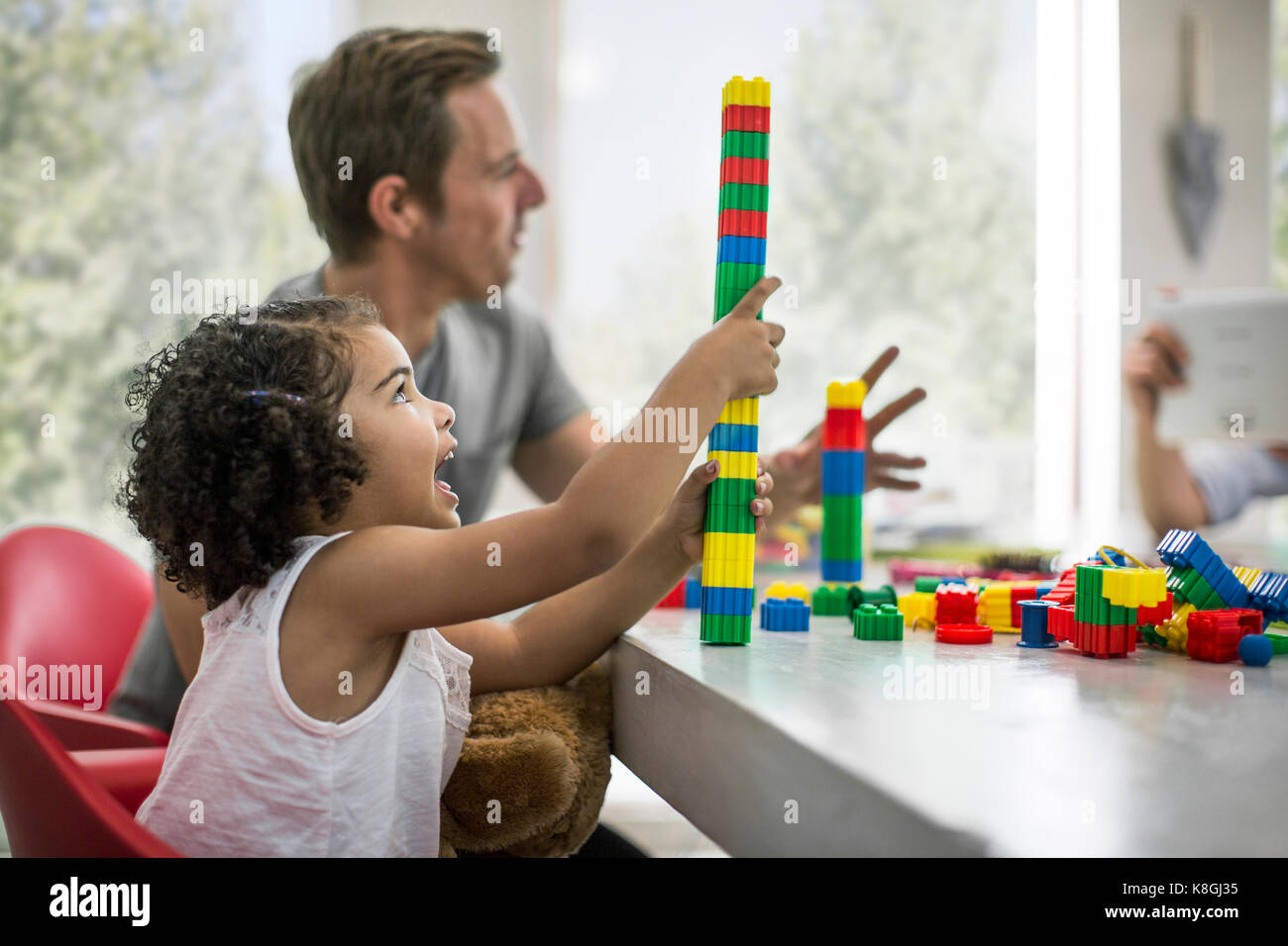 Family playing with building blocks Stock Photo - Alamy