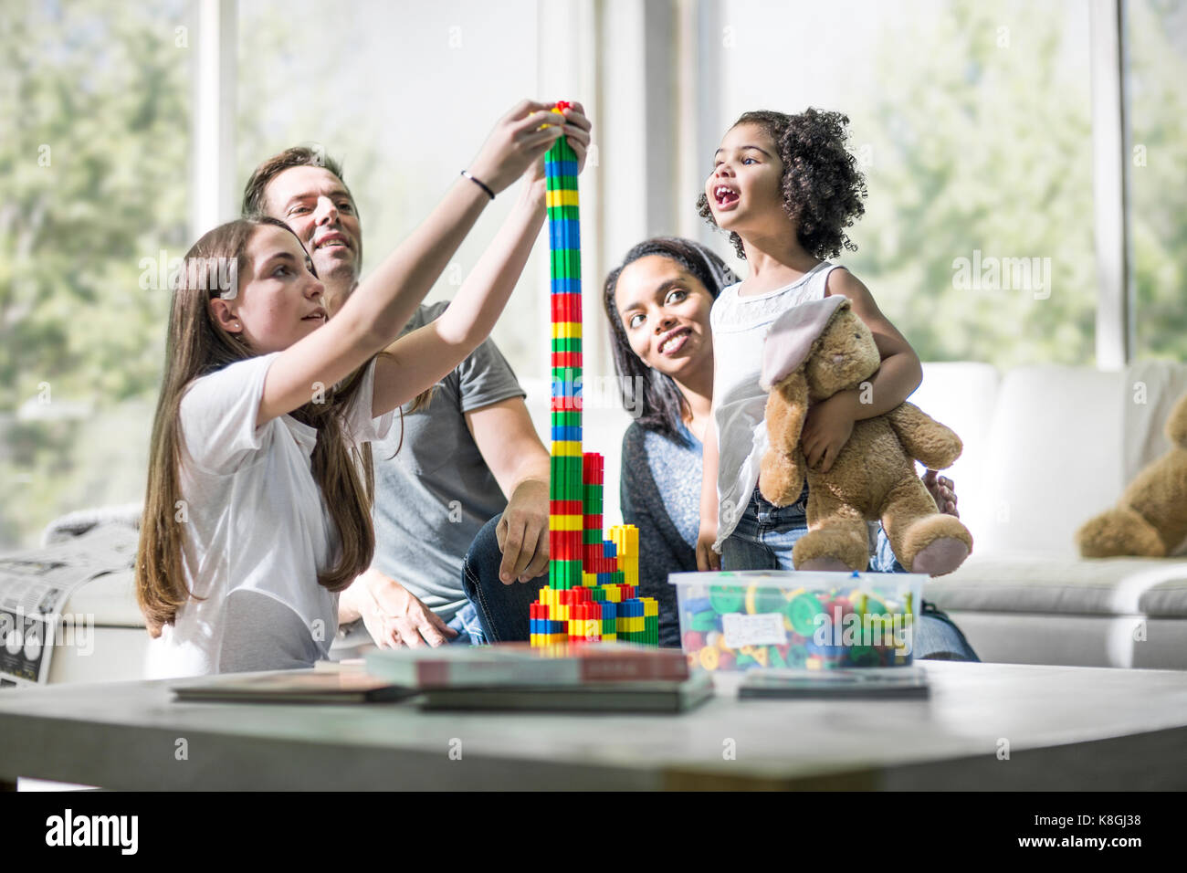 Family playing with building blocks Stock Photo - Alamy