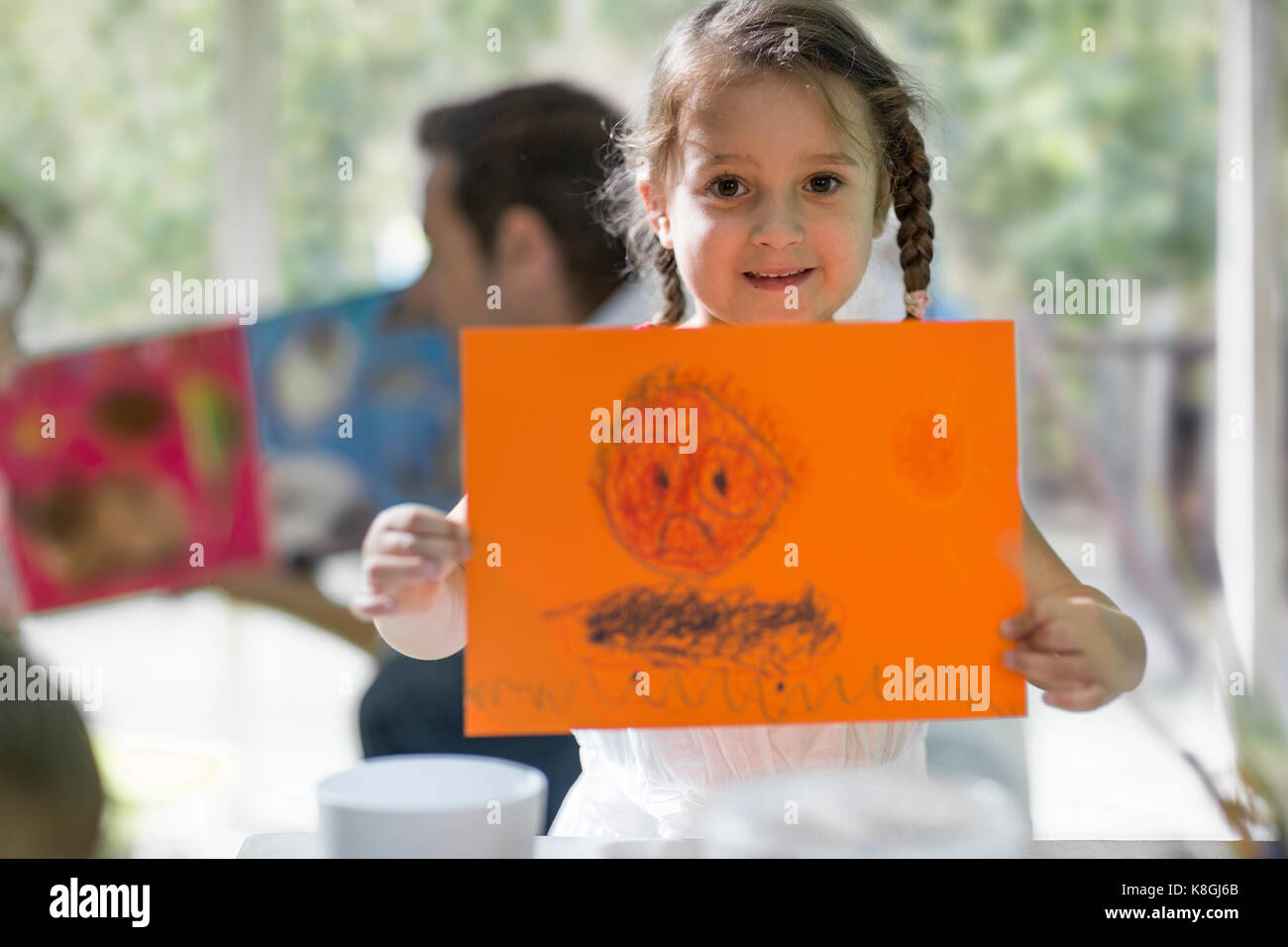 Girl showing drawing Stock Photo - Alamy