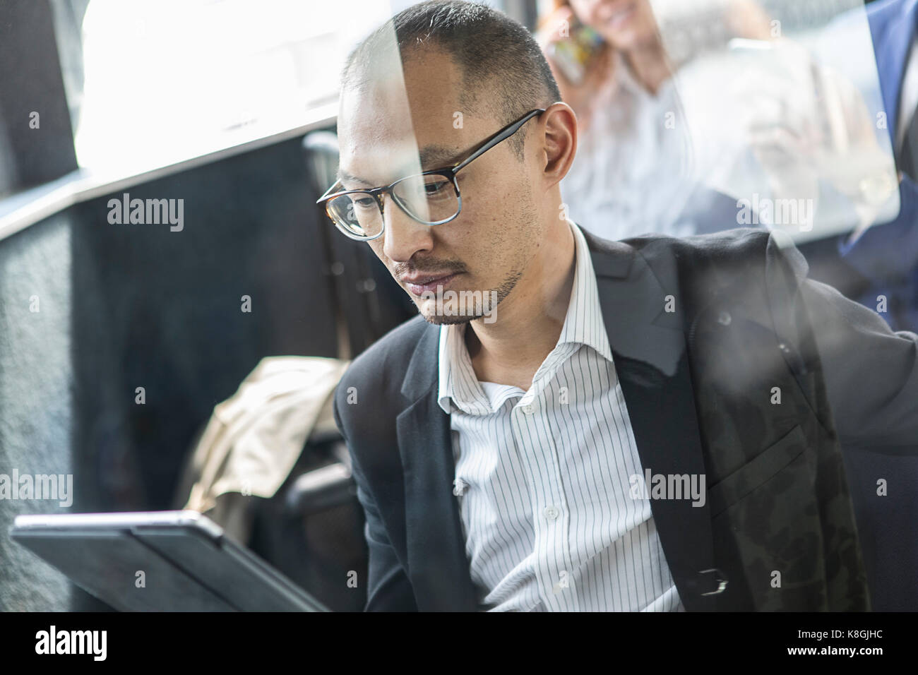 Male passenger using tablet on hi-res stock photography and images - Alamy