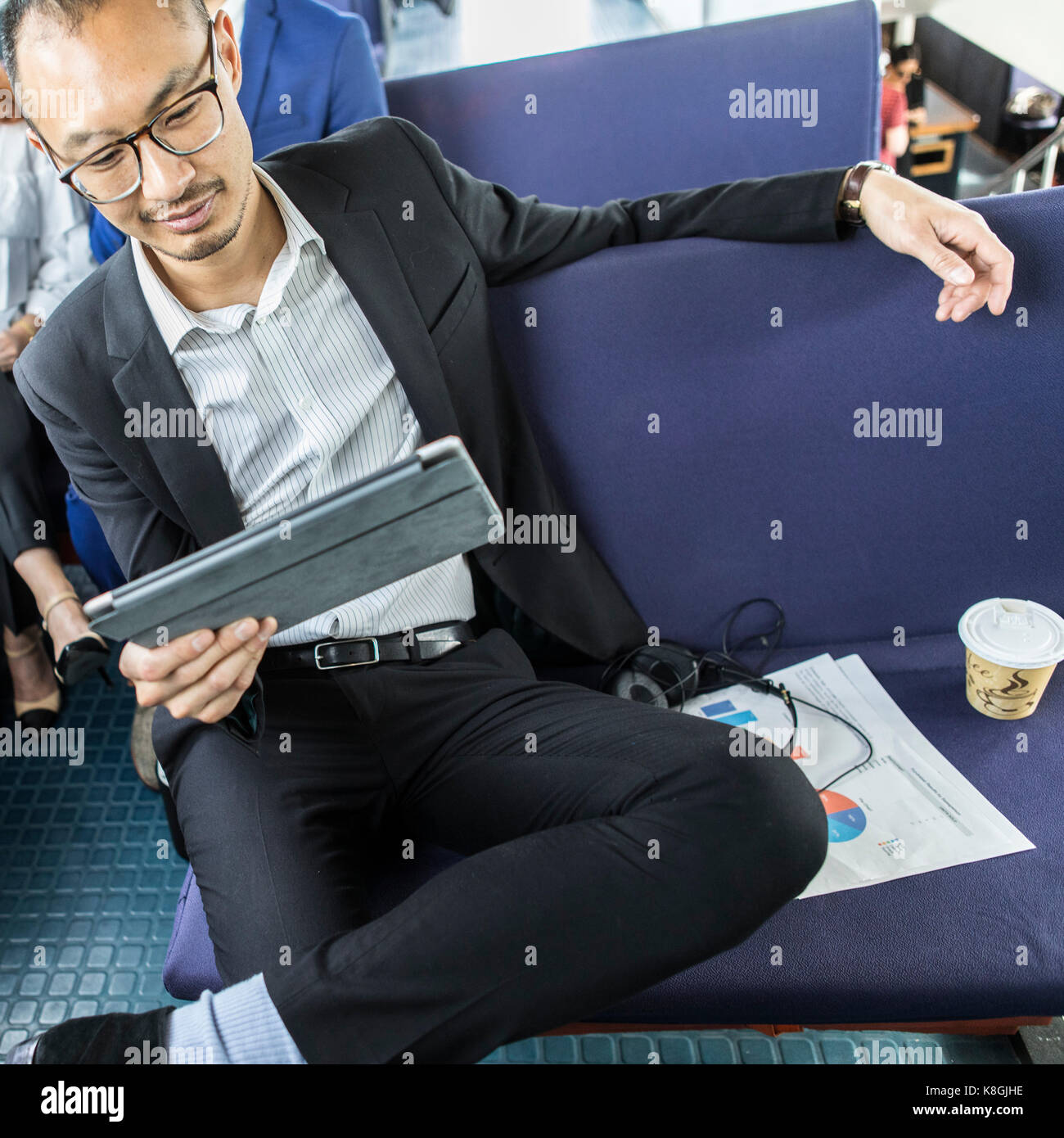 Cool businessman looking at digital tablet on passenger ferry Stock ...