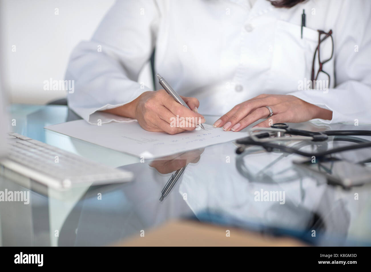 Cropped view of doctor writing prescription Stock Photo - Alamy