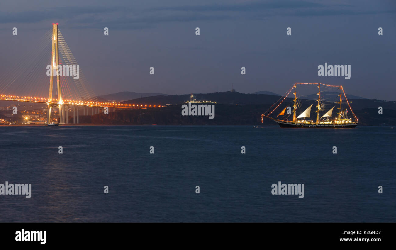 Evening image of sea bay with ship, bridge Stock Photo - Alamy