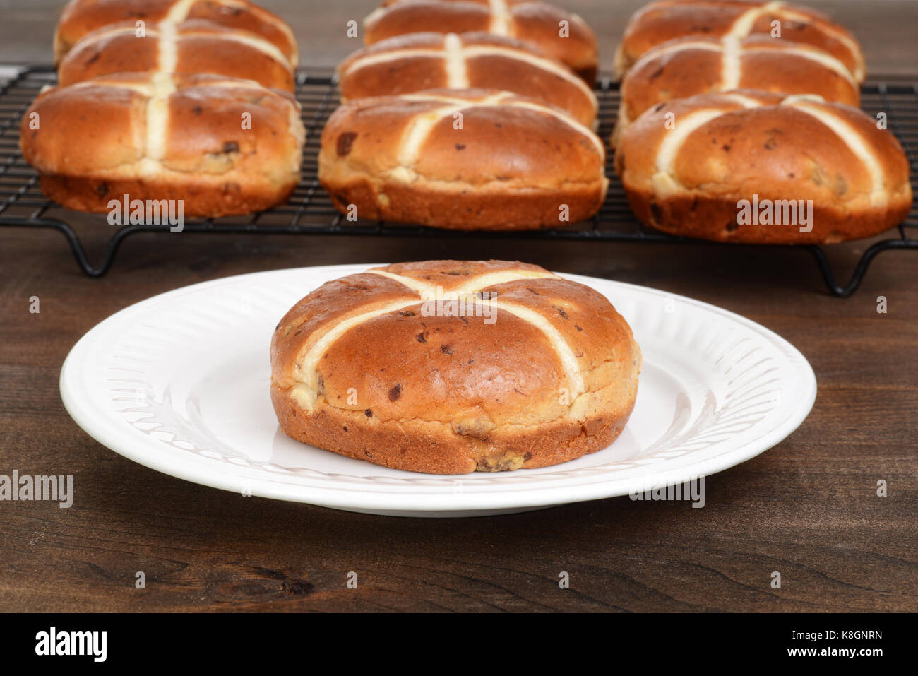 hot cross bun on a plate Stock Photo - Alamy