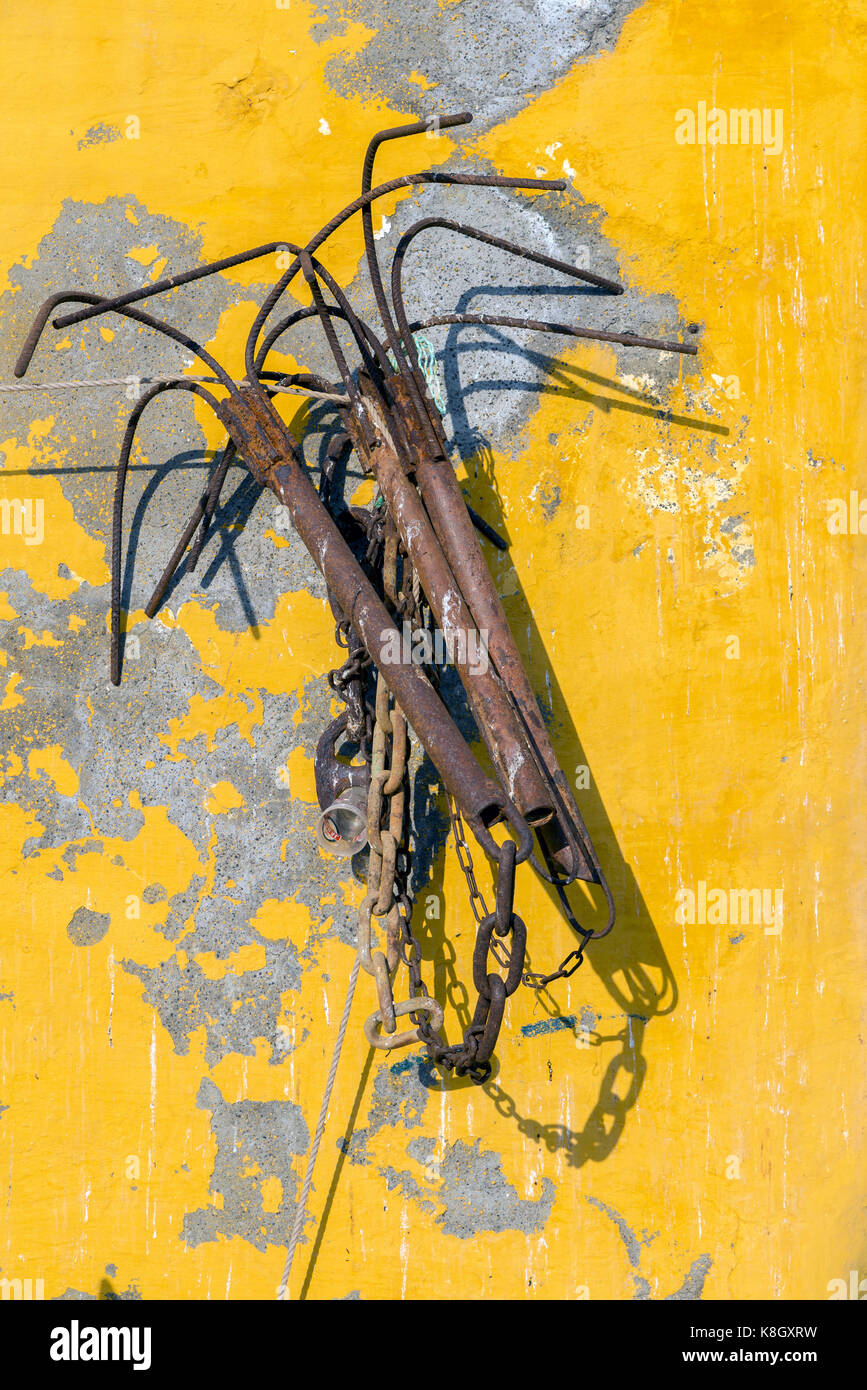 rusty anchors and yellow wall Stock Photo - Alamy