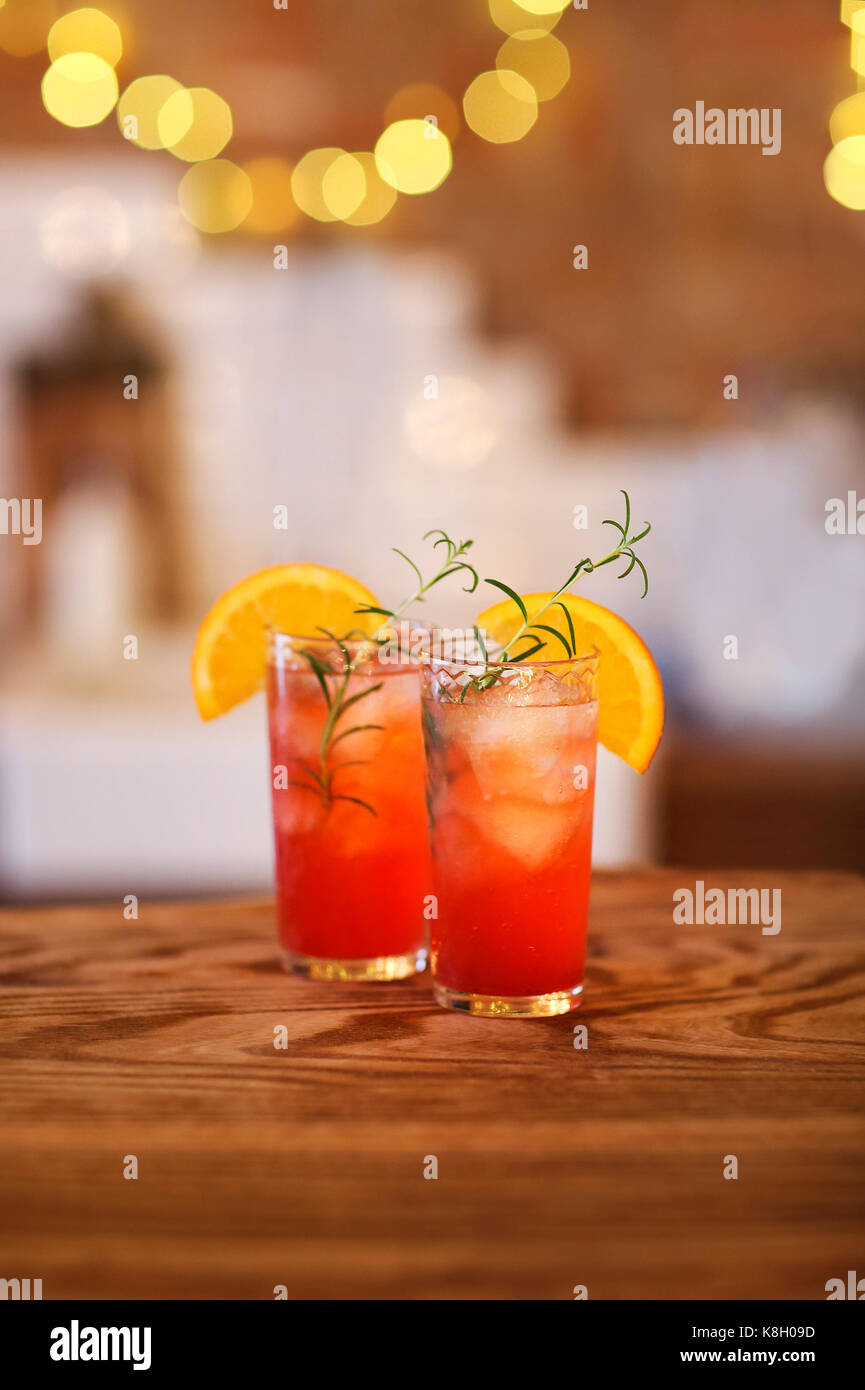 Two red cocktail glasses on wooden bar counter Stock Photo - Alamy