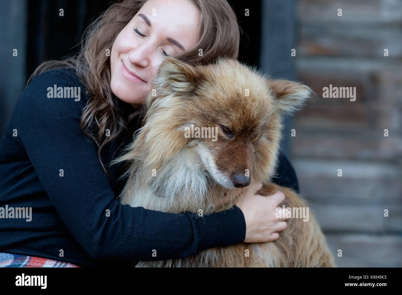 A beautiful woman and her dog nenets shepherd laika sitting Stock Photo ...