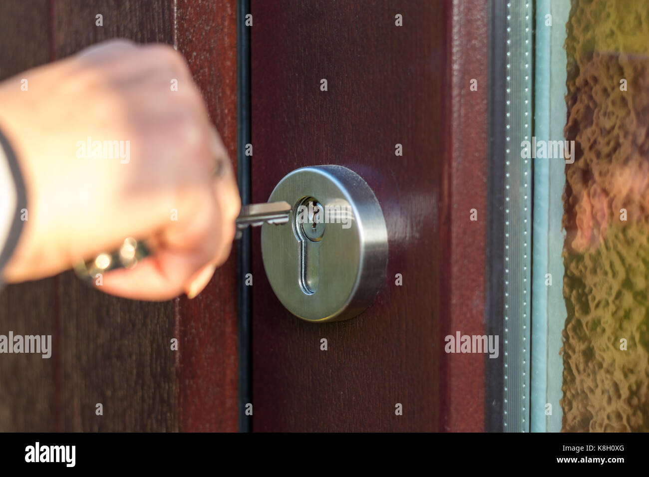 Keys woman opening door hi-res stock photography and images - Alamy