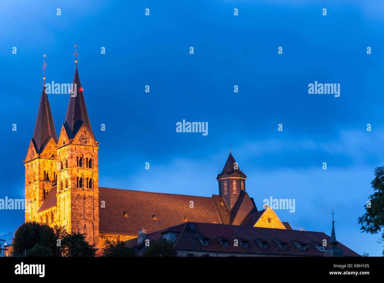 The illuminated cathedral of the small German town Fritzlar during blue ...