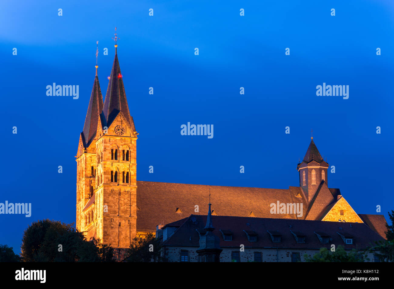 The illuminated cathedral of the small German town Fritzlar during blue ...