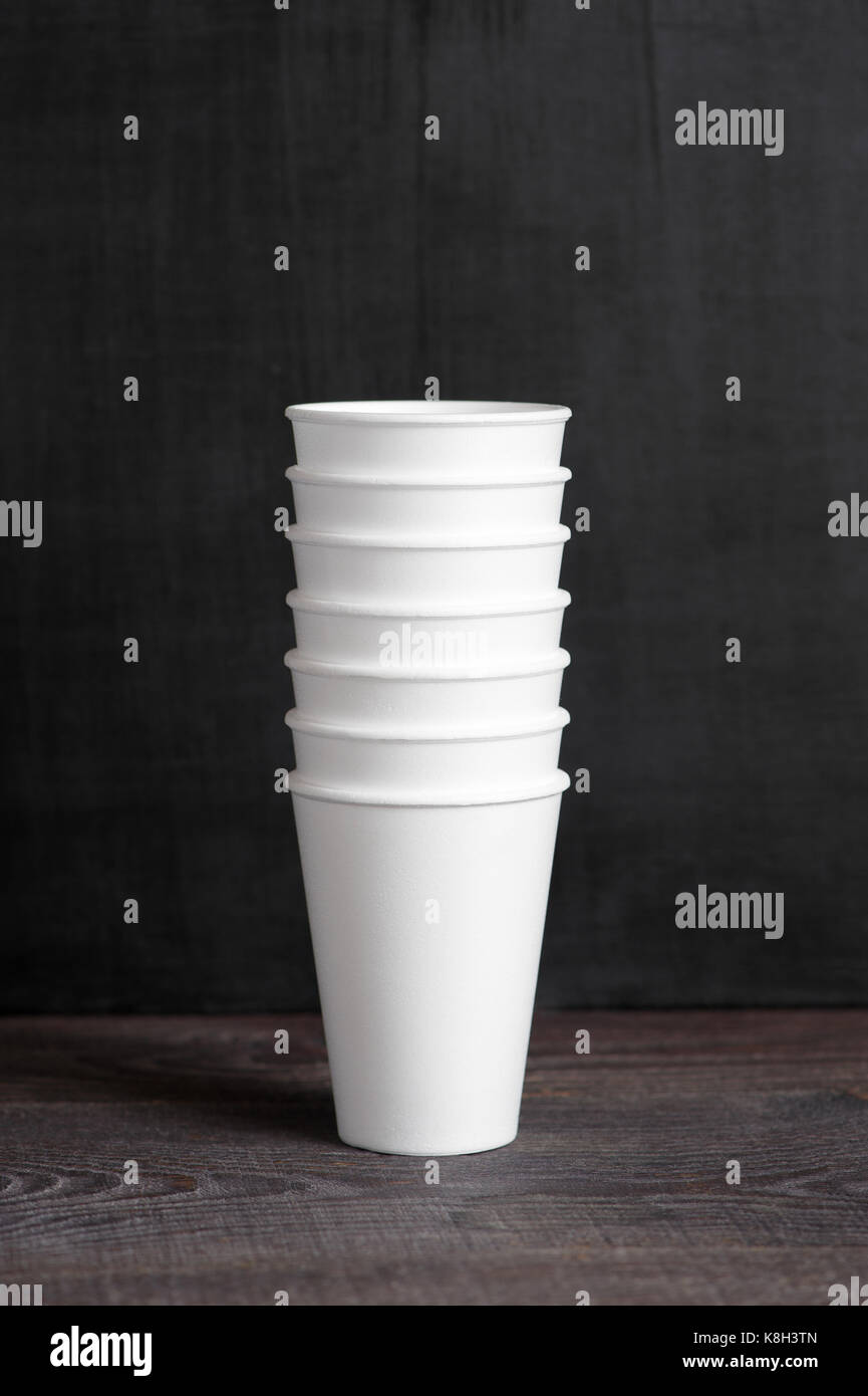 Stack of disposable cups on the dark brown table Stock Photo - Alamy