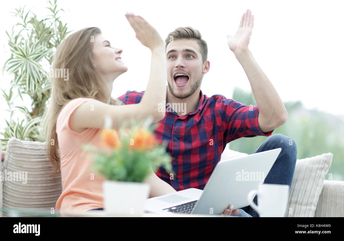 happy young couple giving each other a high five Stock Photo - Alamy