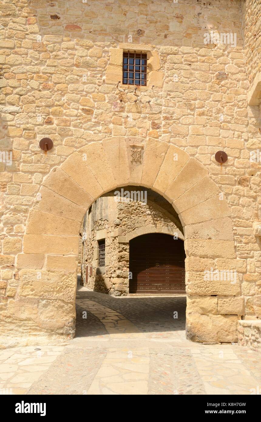 Stone arch in the medieval village of Pals, located in the middle of ...