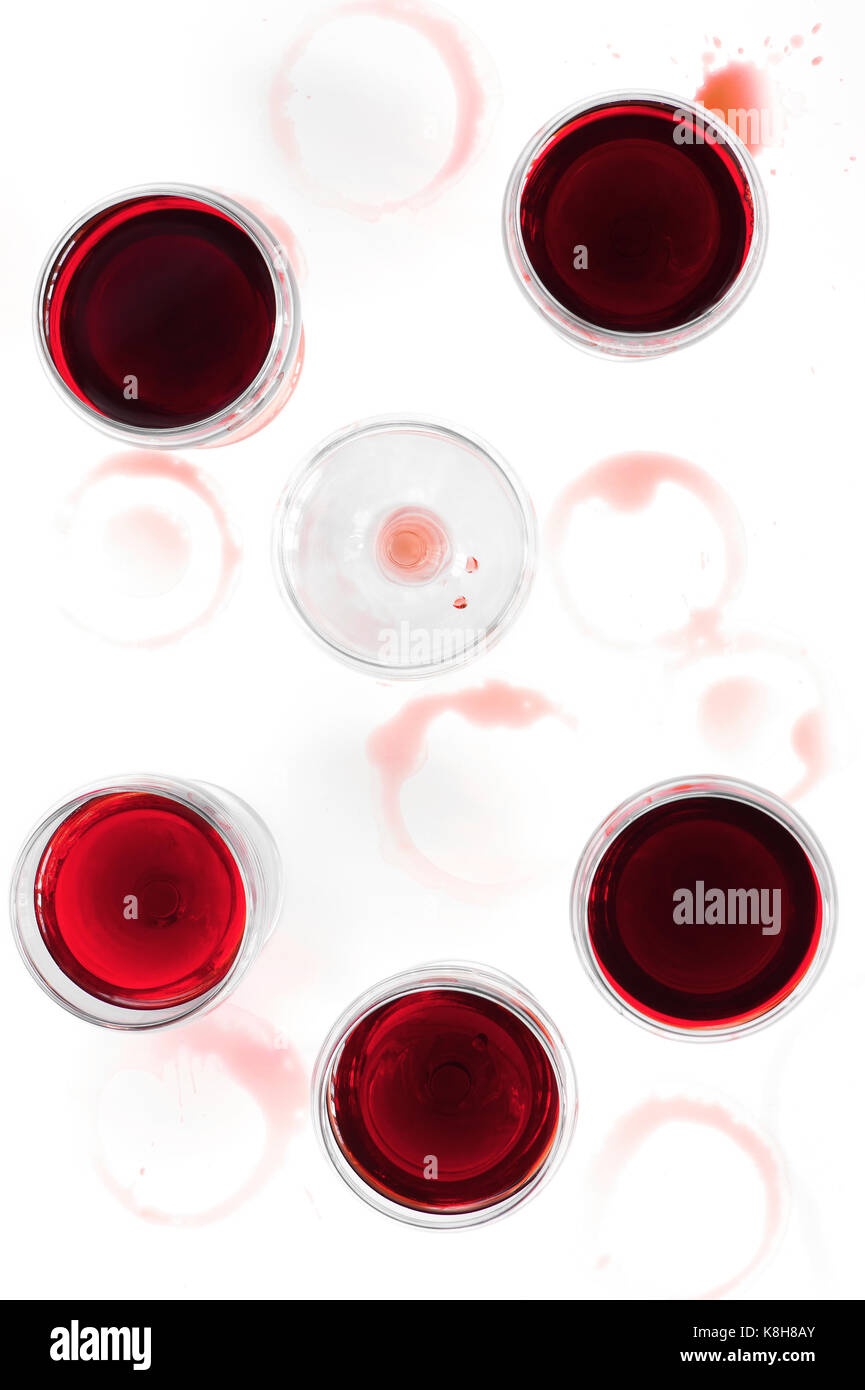 Wine glasses with red wine on the stained white table Stock Photo - Alamy