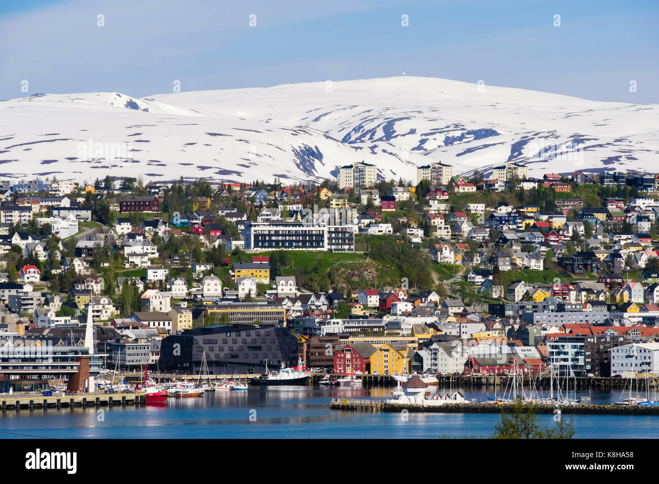 View across harbour to old city buildings on Tromsoya island in summer ...