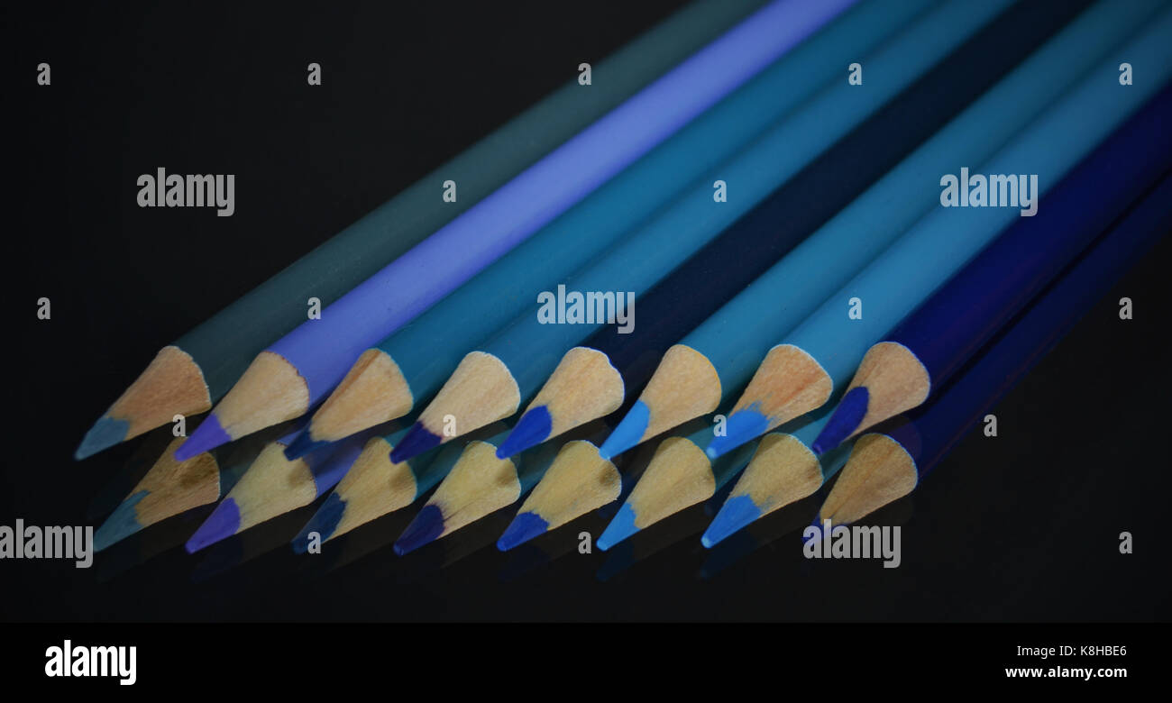 Blue Colored Pencils on Mirror with Reflection on a Black Background ...