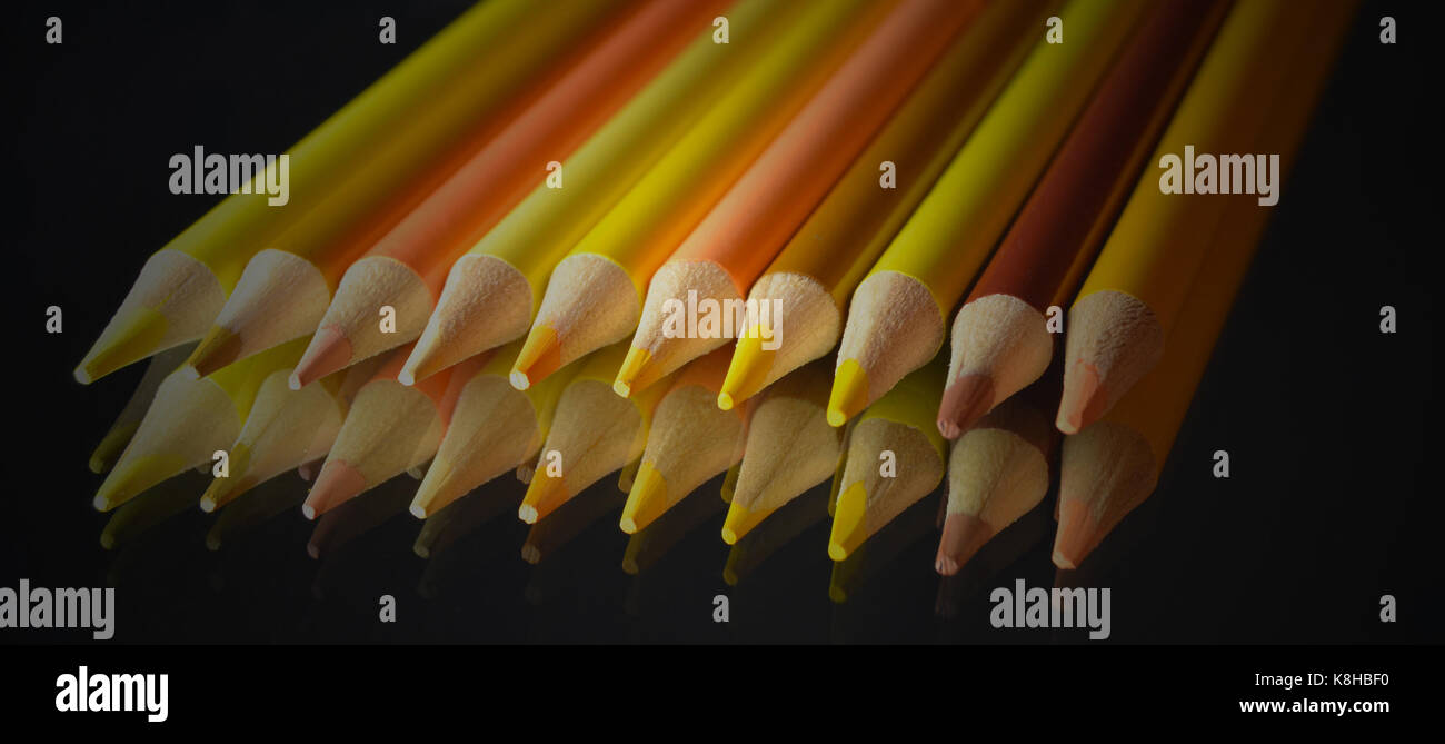 Yellow Colored Pencils with Reflection on Mirror on a Black Background ...