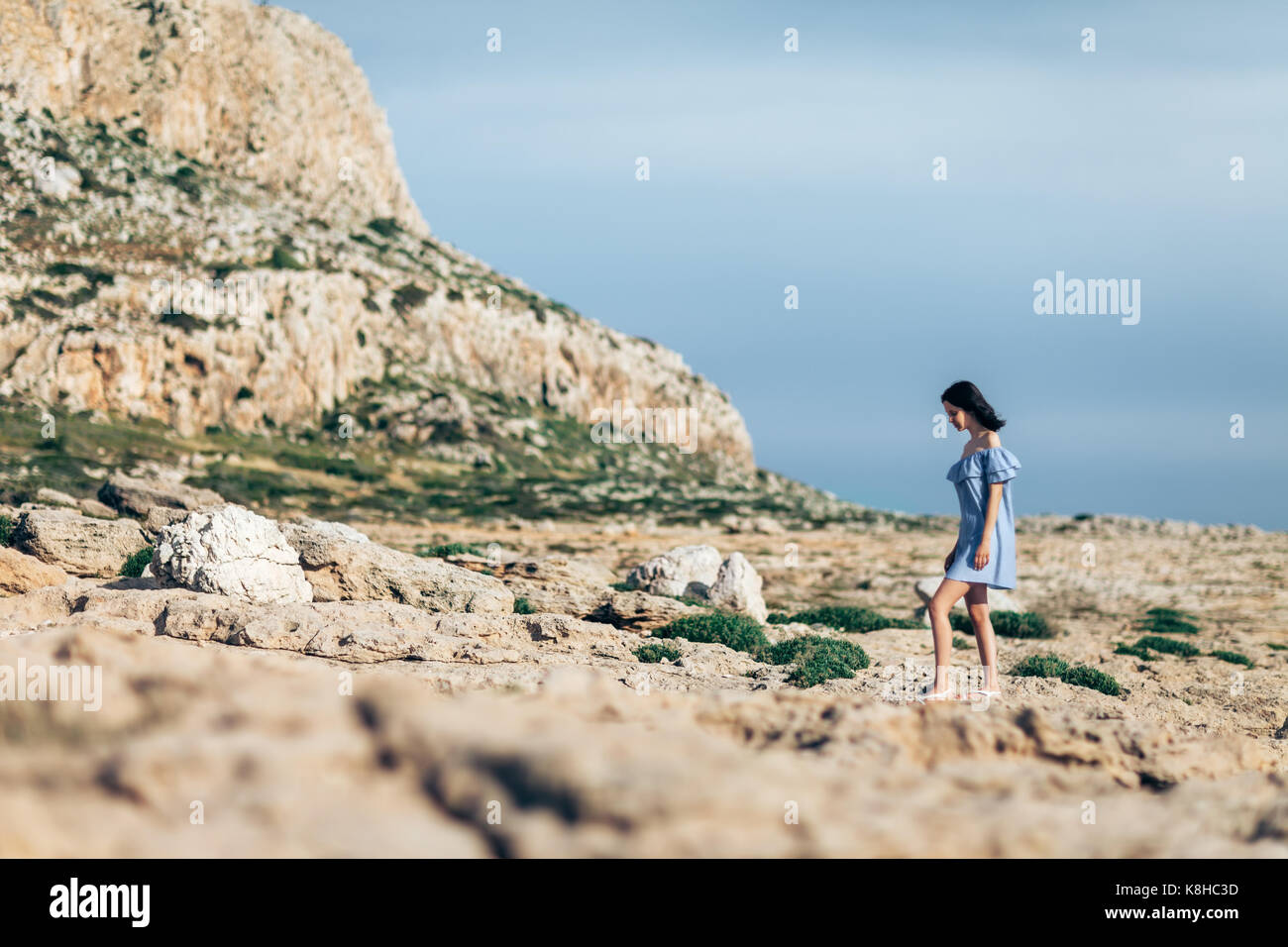 Beautiful alone woman walking on rocky desert with dramatic sky Stock ...
