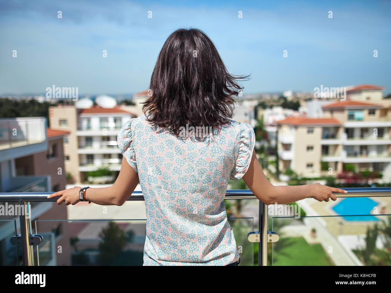 Beautiful woman enjoying cityscape standing on rooftop Stock Photo - Alamy