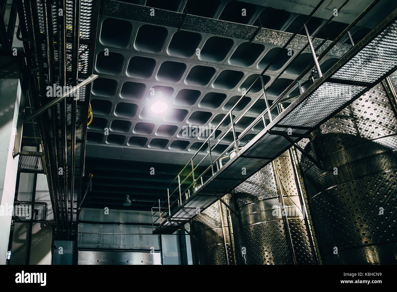 Metal ceiling and tanks in a row inside the winery factory Stock Photo ...