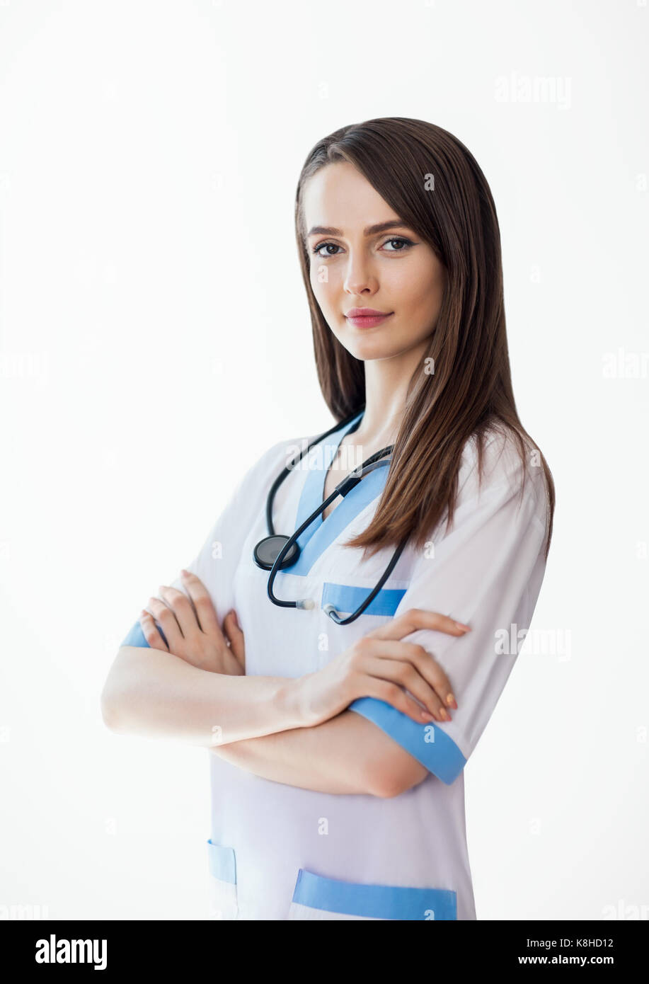 Portrait of confident beautiful doctor with arms crossed on white ...