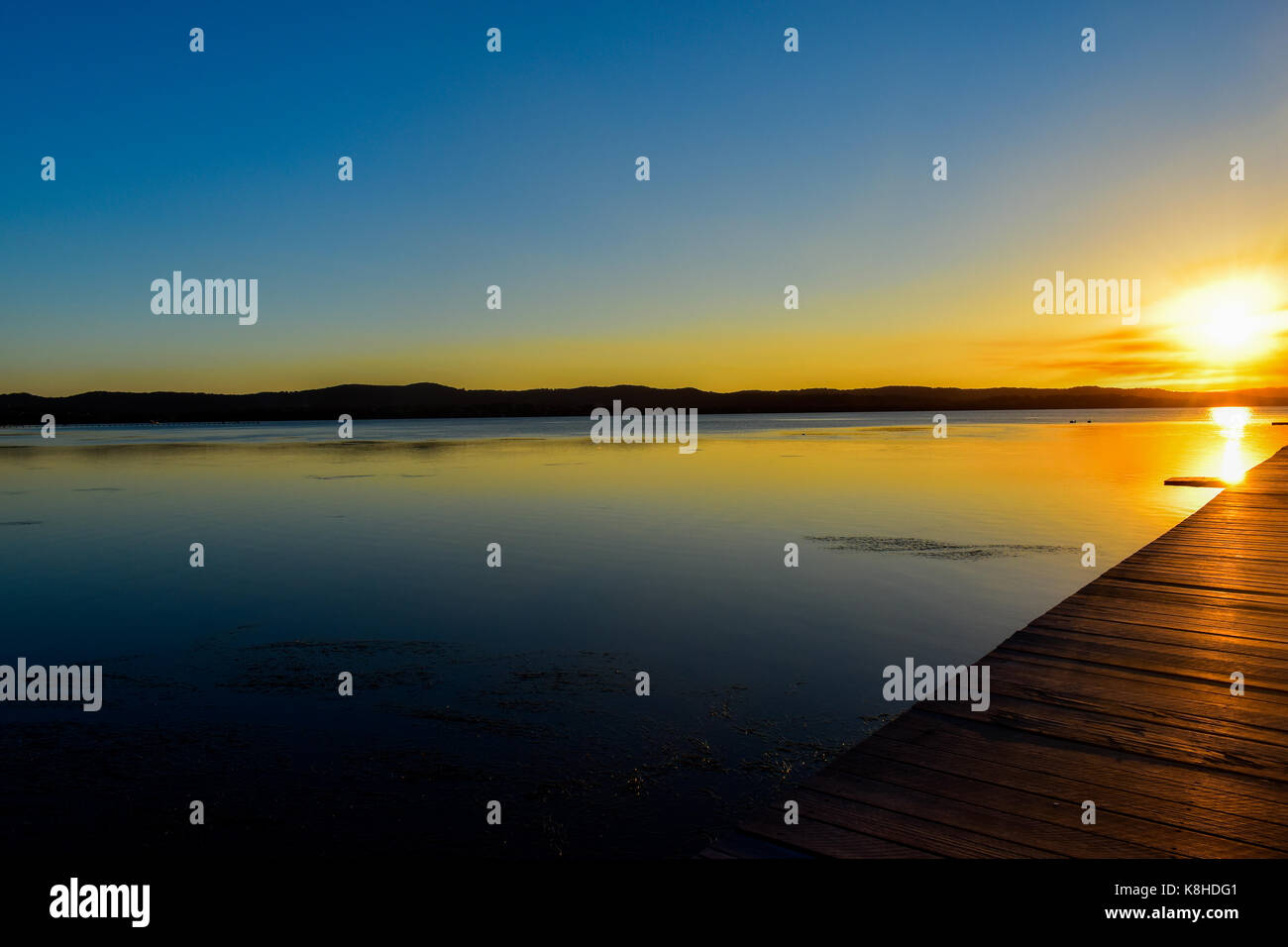Watching the sunset on Long Jetty, NSW Australia Stock Photo - Alamy