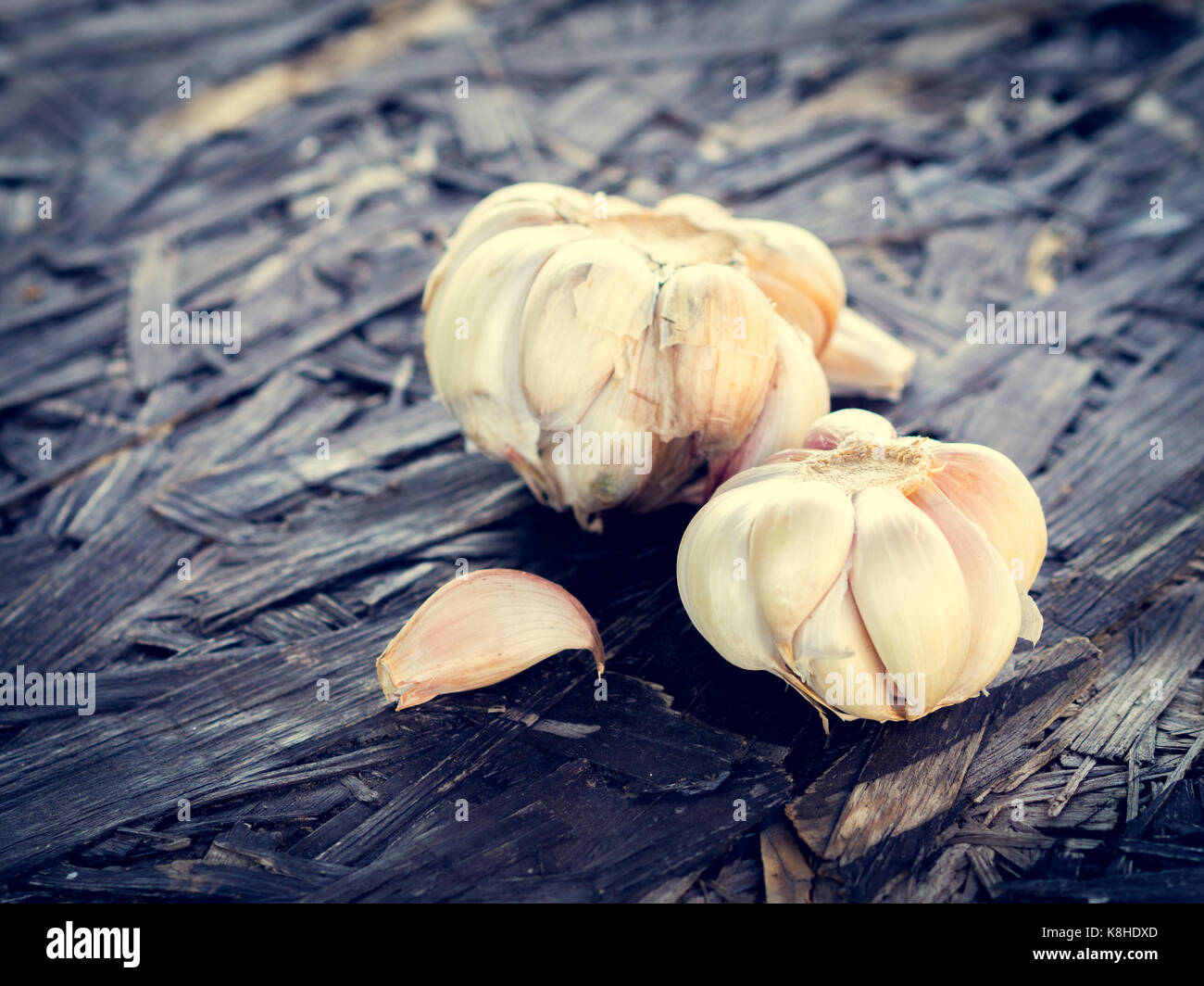 close up of a garlic on the dark wooden background Stock Photo - Alamy